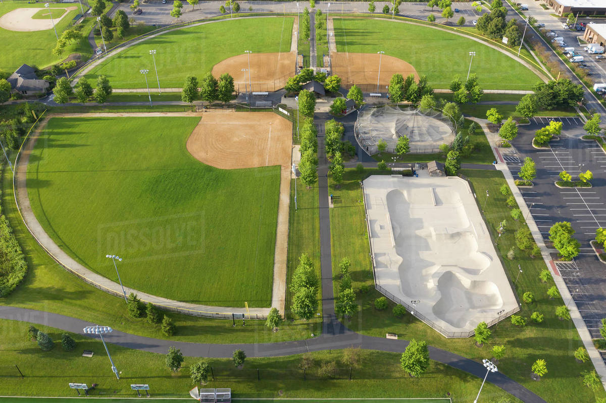 Aerial view of a suburban baseball/softball sports complex with batting ...