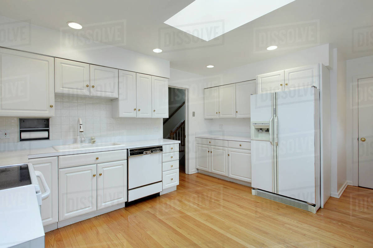 Kitchen in suburban home with white cabinetry. - Royalty-free Stock ...
