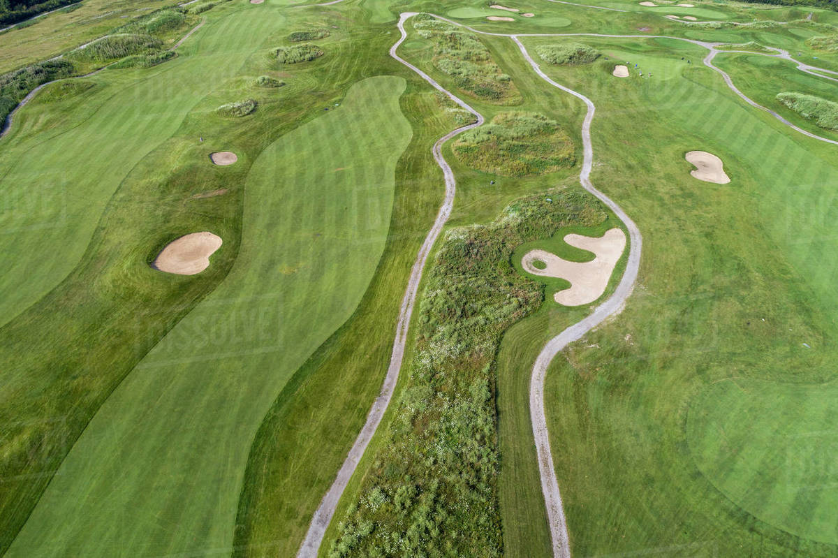 Aerial view of a links-style golf course in a suburban setting in ...