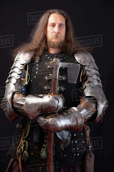 Vertical composition. Portrait of a medieval knight with an axe and ...