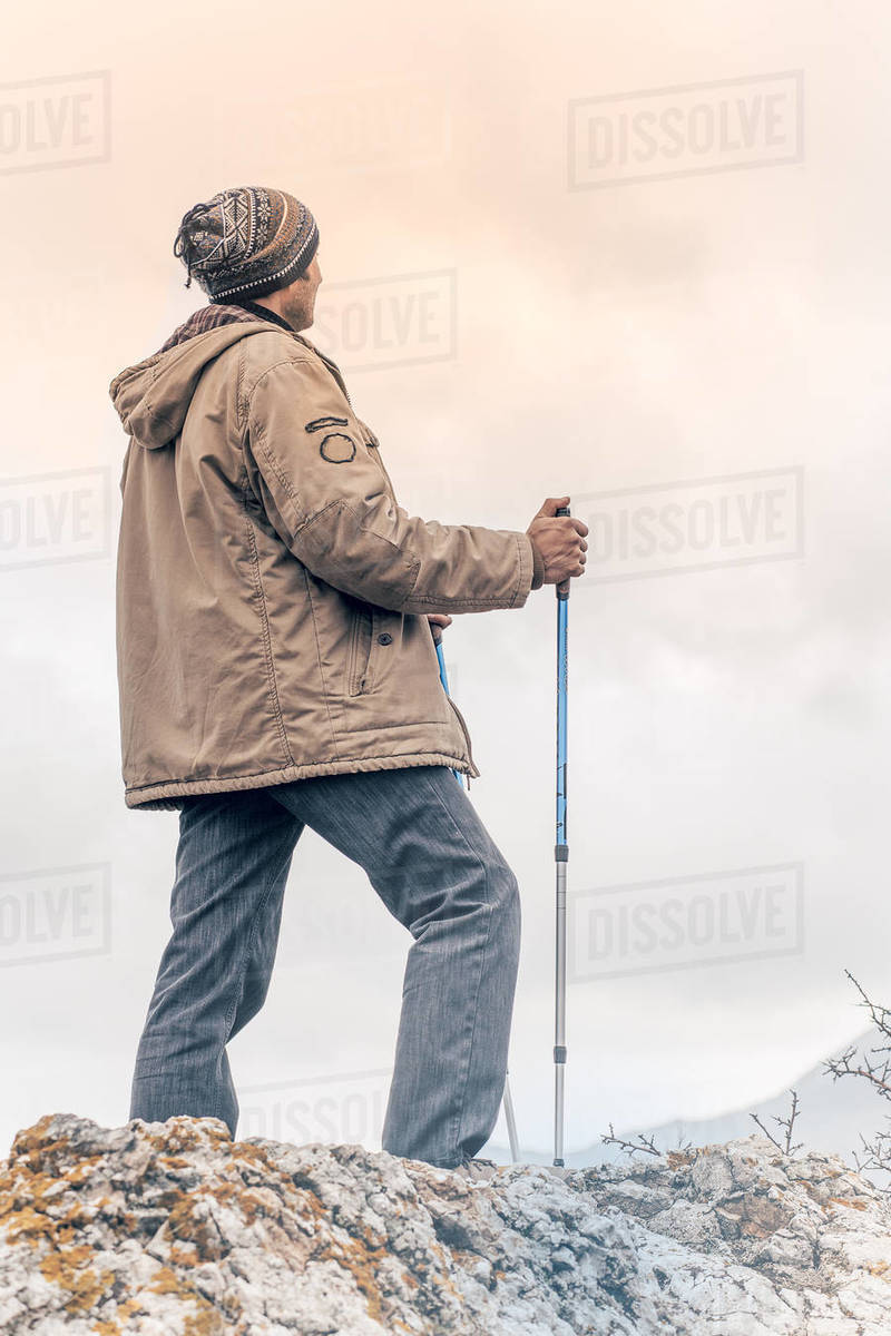 A hiker with sticks in hands enjoys the view - Royalty-free Stock Photo ...