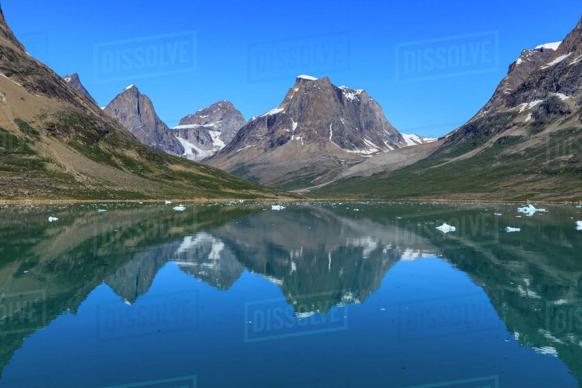 Reflections, beautiful mountains, rugged South Skjoldungen Fjord and ...