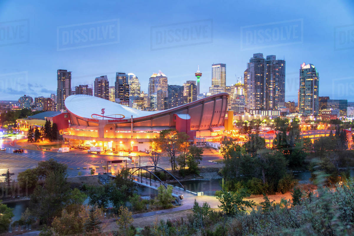 View of the Saddledome and Downtown skyline from Scottsman Hill at dusk ...