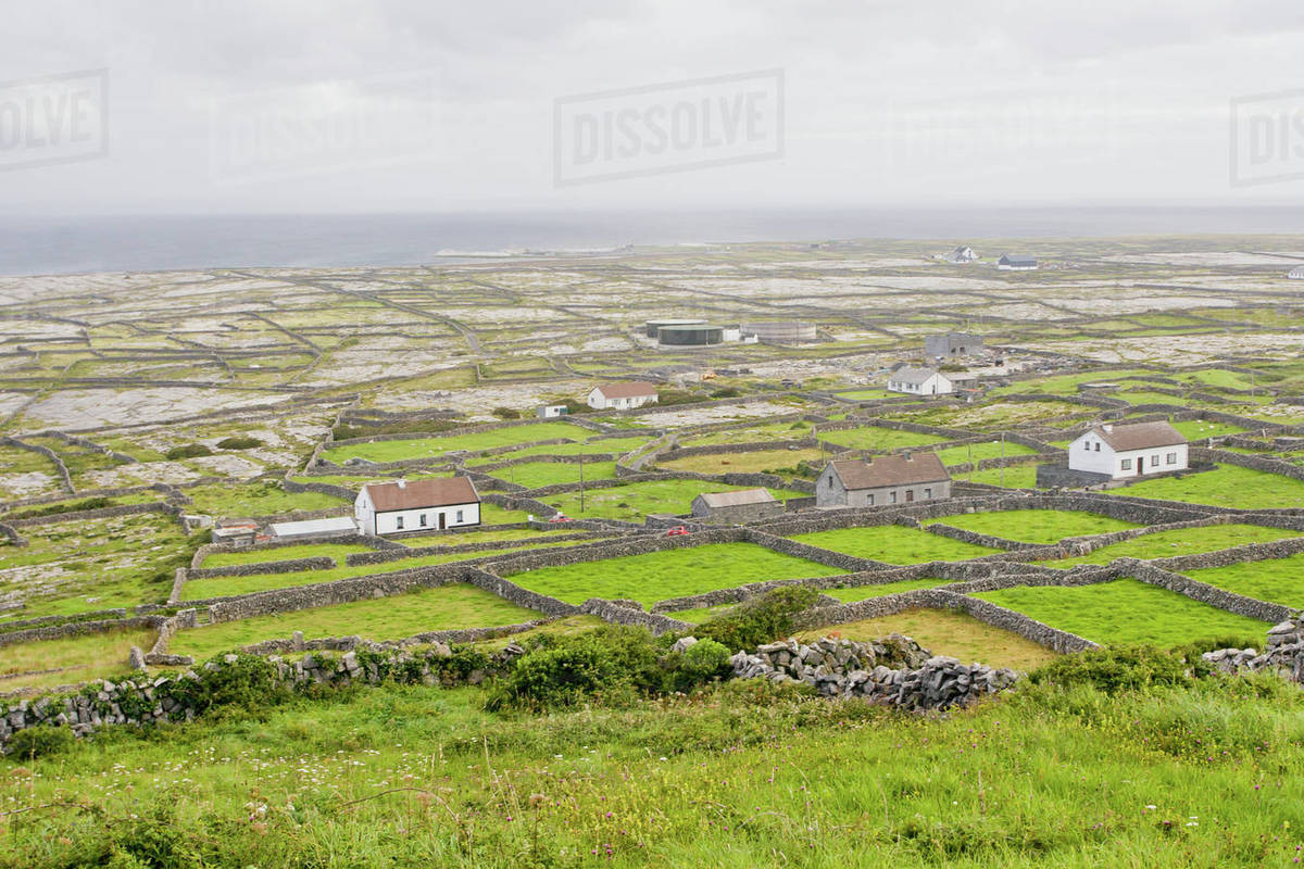 Bleak flat landscape of stone-walled farms, Inishmaan, Aran Islands ...
