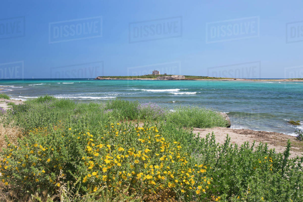 View across bay to the island fortress of Capo Passero, Portopalo di ...