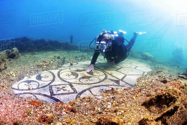 Diver swimming over a submerged ancient Roman mosaic, Baia (Baiae ...