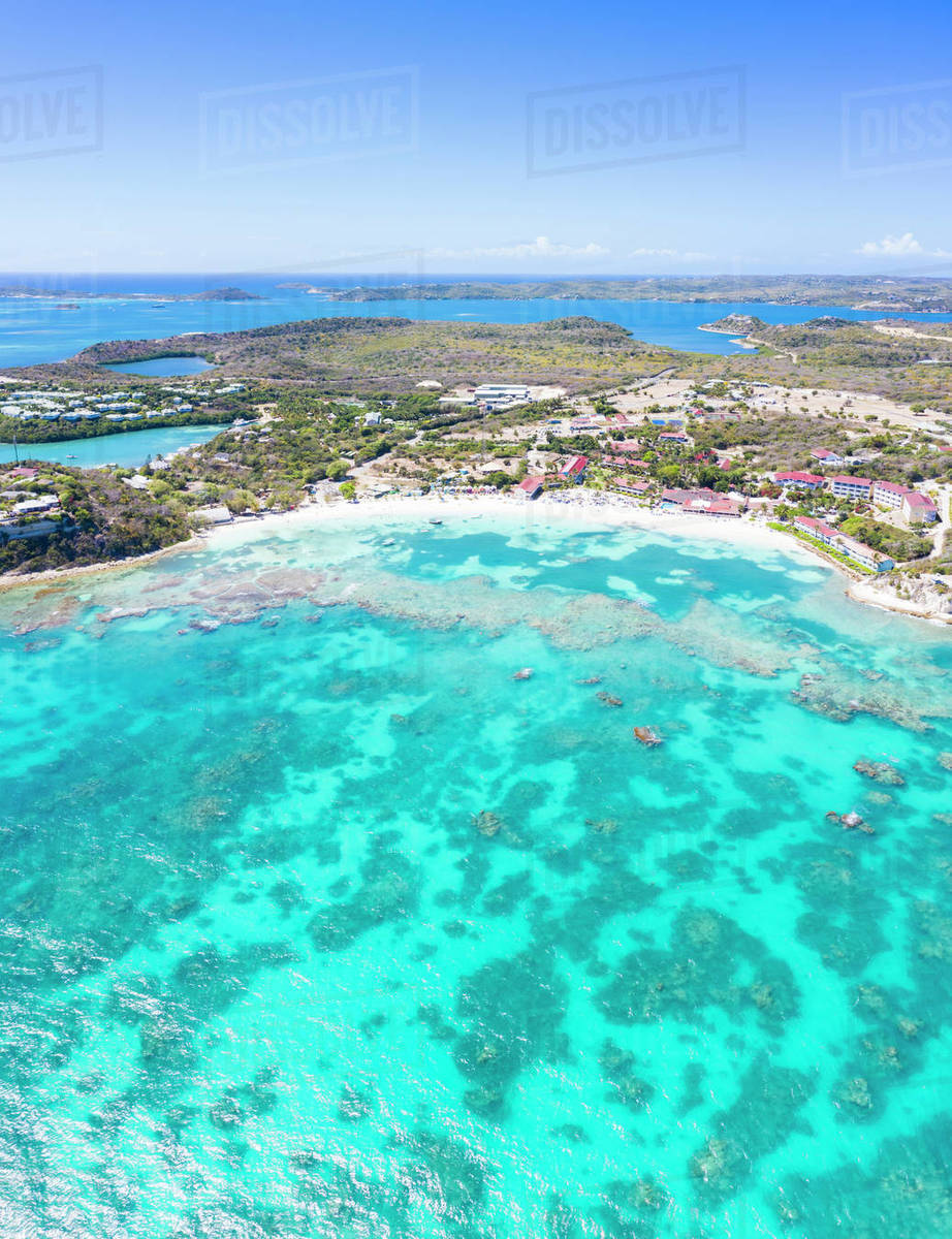 Aerial panoramic of white sand beach and coral reef, Long Bay, Antigua ...