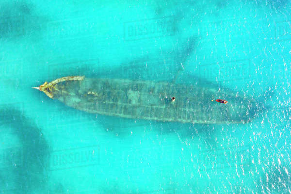 Aerial view by drone of a shipwreck in the shallow water of blue ...