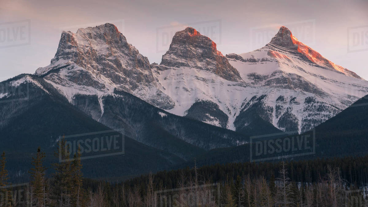 Evening light on the peaks of Three Sisters near Banff National Park, Canmore, Alberta, Canadian ...