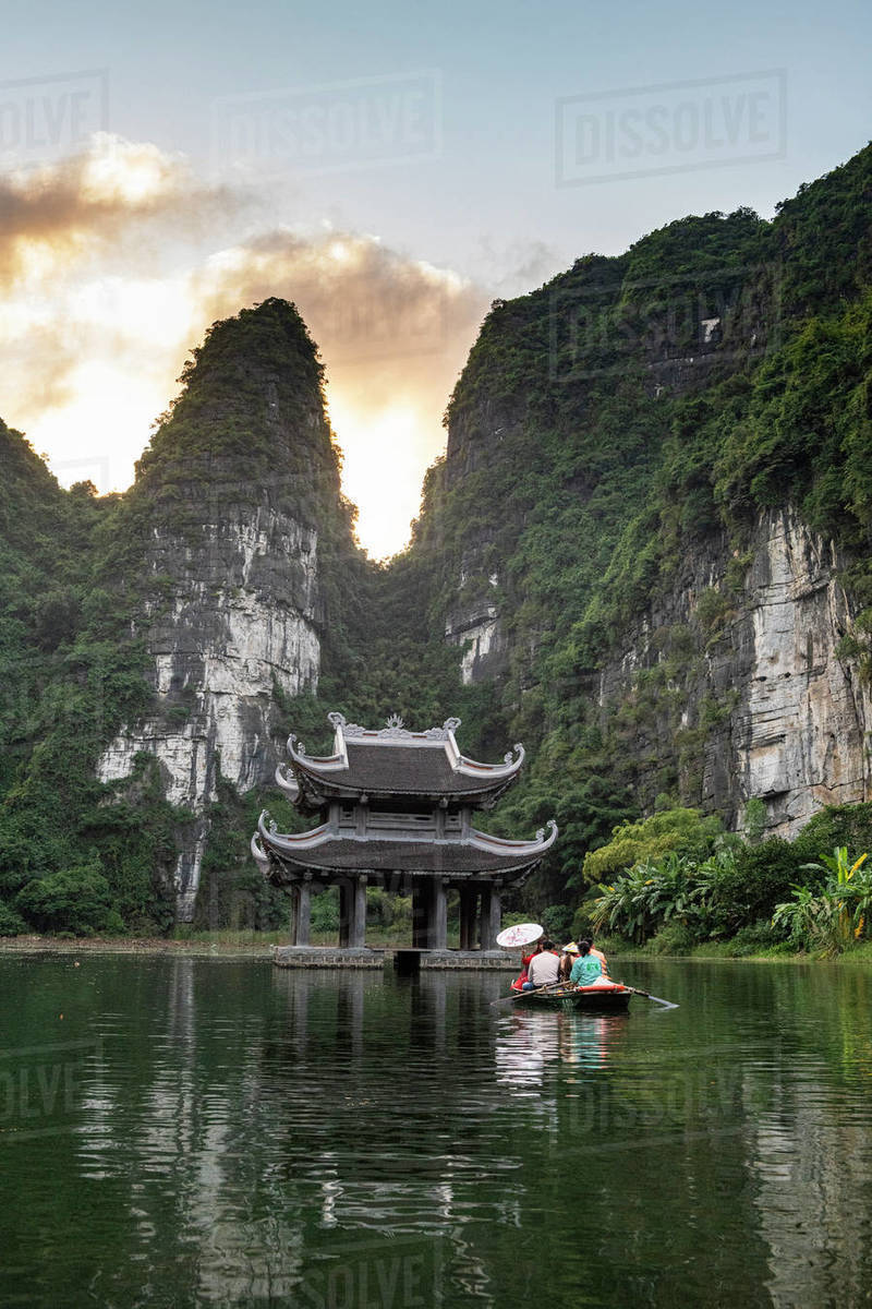 Temple standing between the scenic limestone mountains of Trang An ...