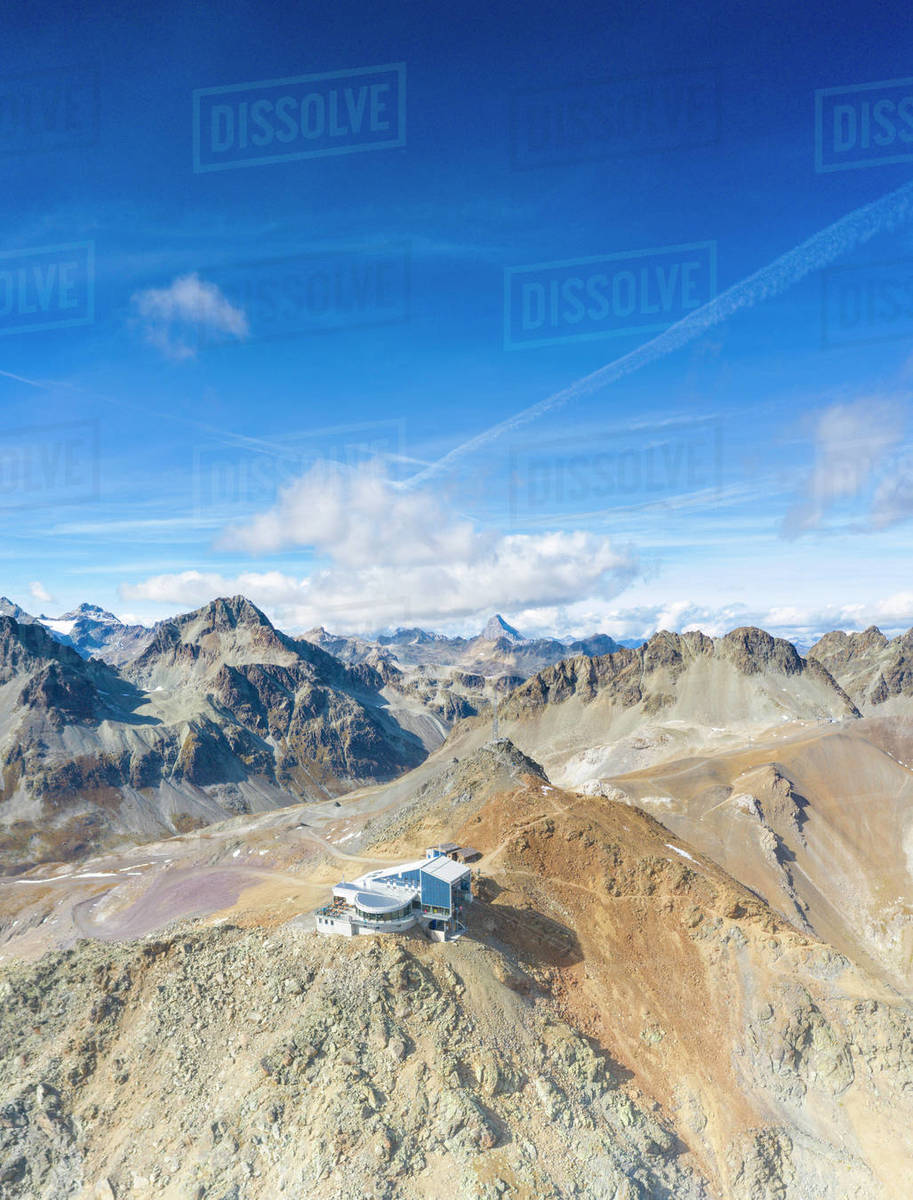 Aerial by drone of clear sky over Piz Nair and cable car station on top ...