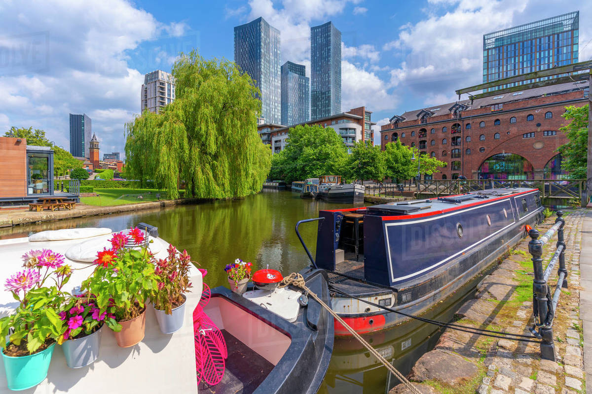 View of canal boat and contemporary skyline from Castlefield ...