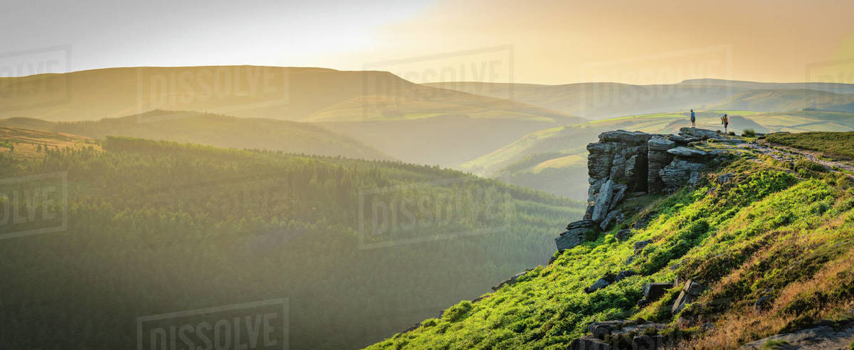 View of climbers on Bamford Edge at sunset, Bamford, Peak District ...