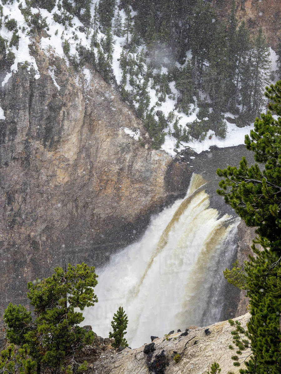 Yellowstone waterfall during a snowstorm in Yellowstone National Park ...