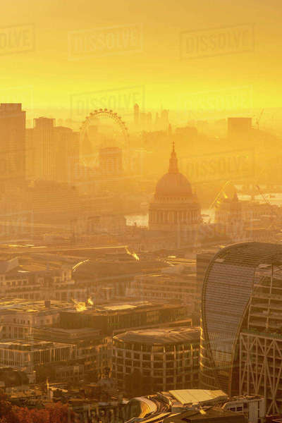 View of London Eye and St. Paul's Cathedral at golden hour from the ...