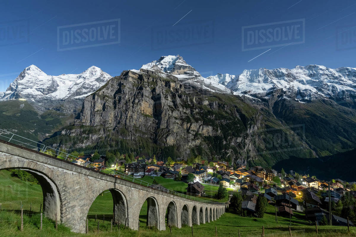 Alpine village of Murren and funicular railway lit by star trail ...