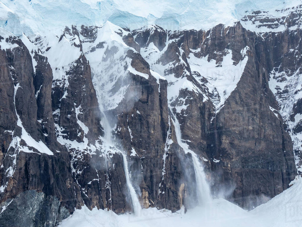 Snow falling in an avalanche on Brabant Island, Antarctica, Polar ...