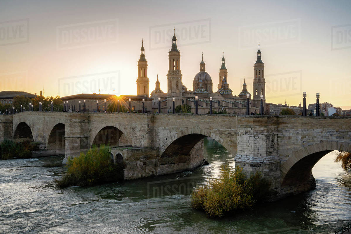 Basilica del Pilar Cathedral with stone bridge crossing Ebro River ...