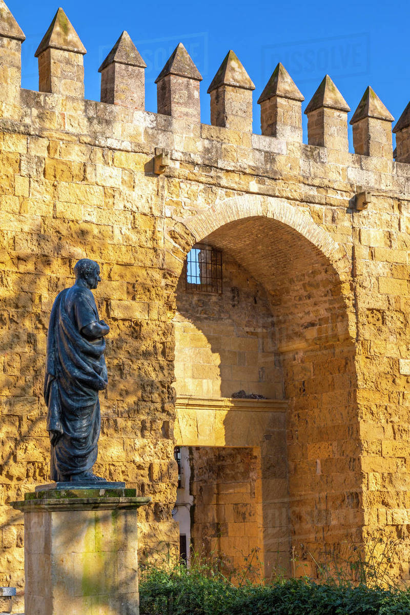Statue of Seneca with the Almodovar Gate and Walls of Cordoba built in ...