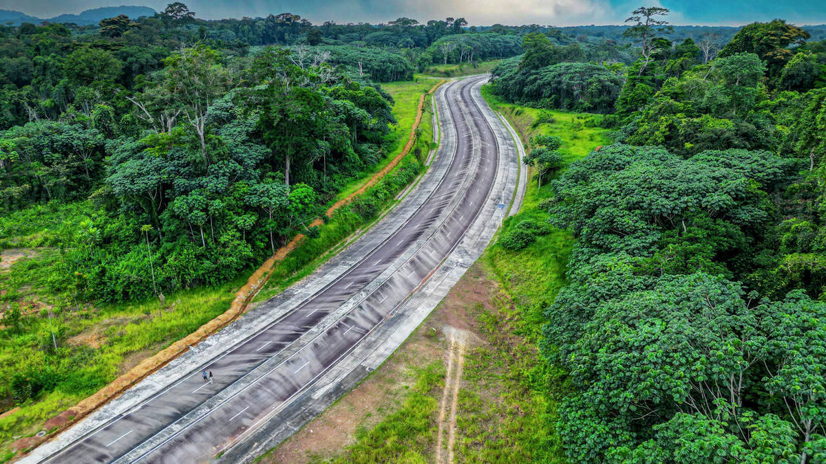 Empty highway in the jungle, future capital Ciudad de la Paz, Rio Muni ...