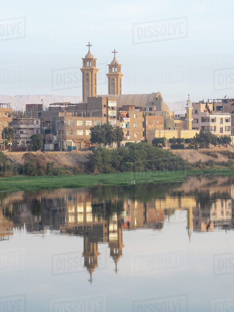 A view of the shoreline along the upper Nile River, with town and ...