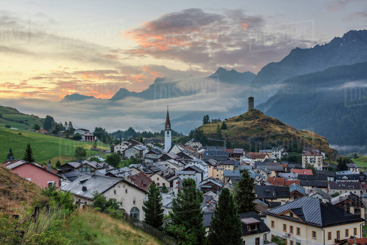 Misty sky on the alpine village of Ardez at sunrise, district of Inn ...