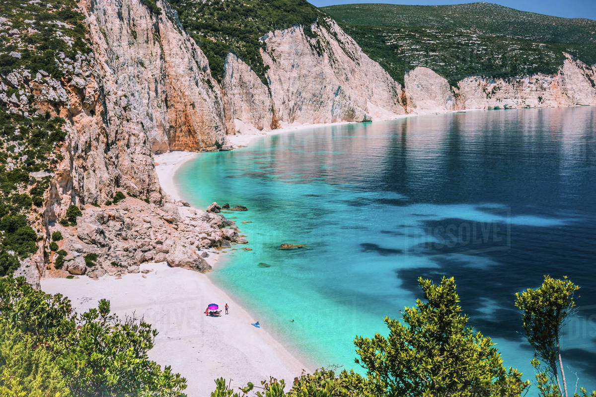 Amazing Fteri beach lagoon, Kefalonia, Greece. Tourists under umbrella ...