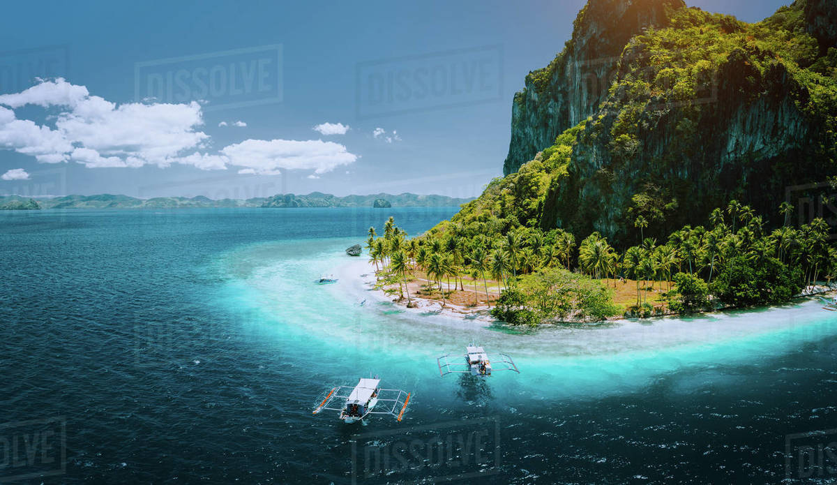 Epic aerial drone panoramic picture of tourist boats arriving tropical ...