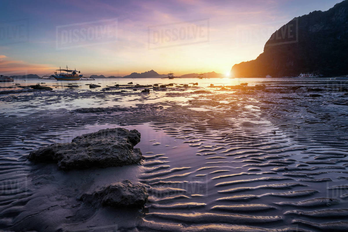 Tropical beach in ebb time low tide on sunset. Mudflats and sun ...