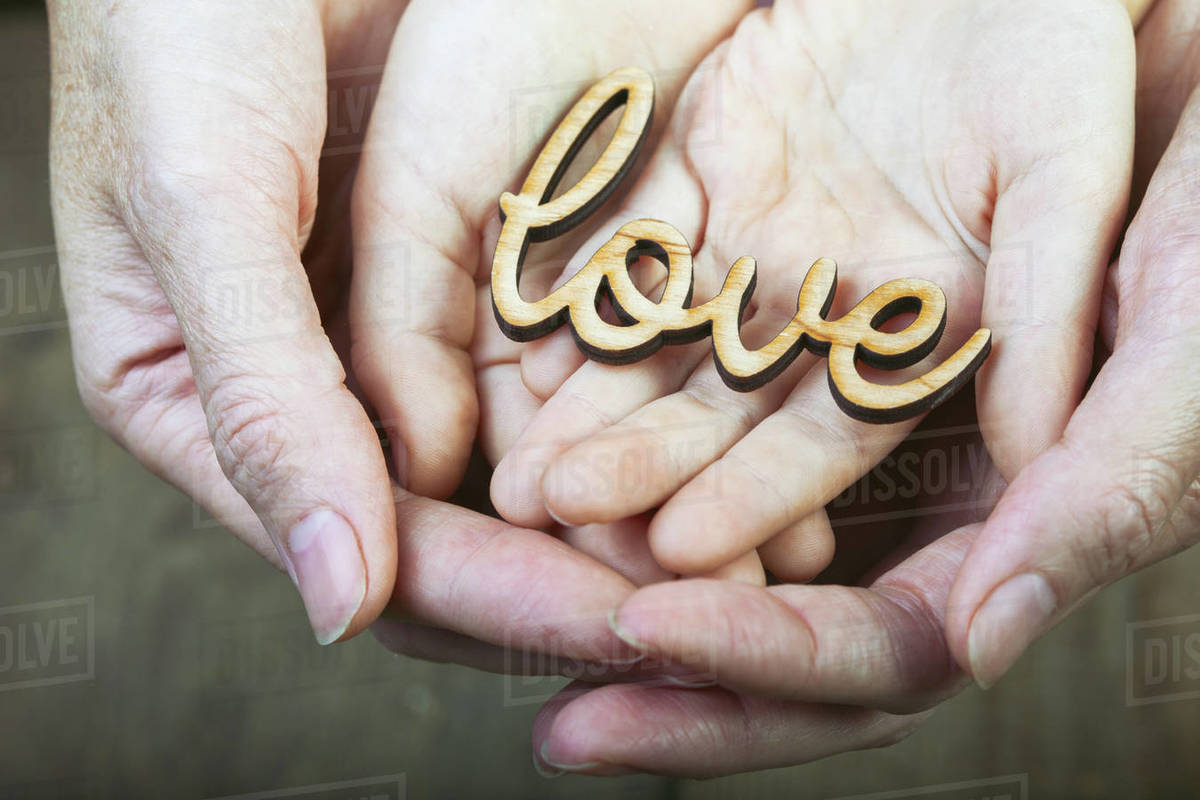 Hands holding word love - Royalty-free Stock Photo | Dissolve