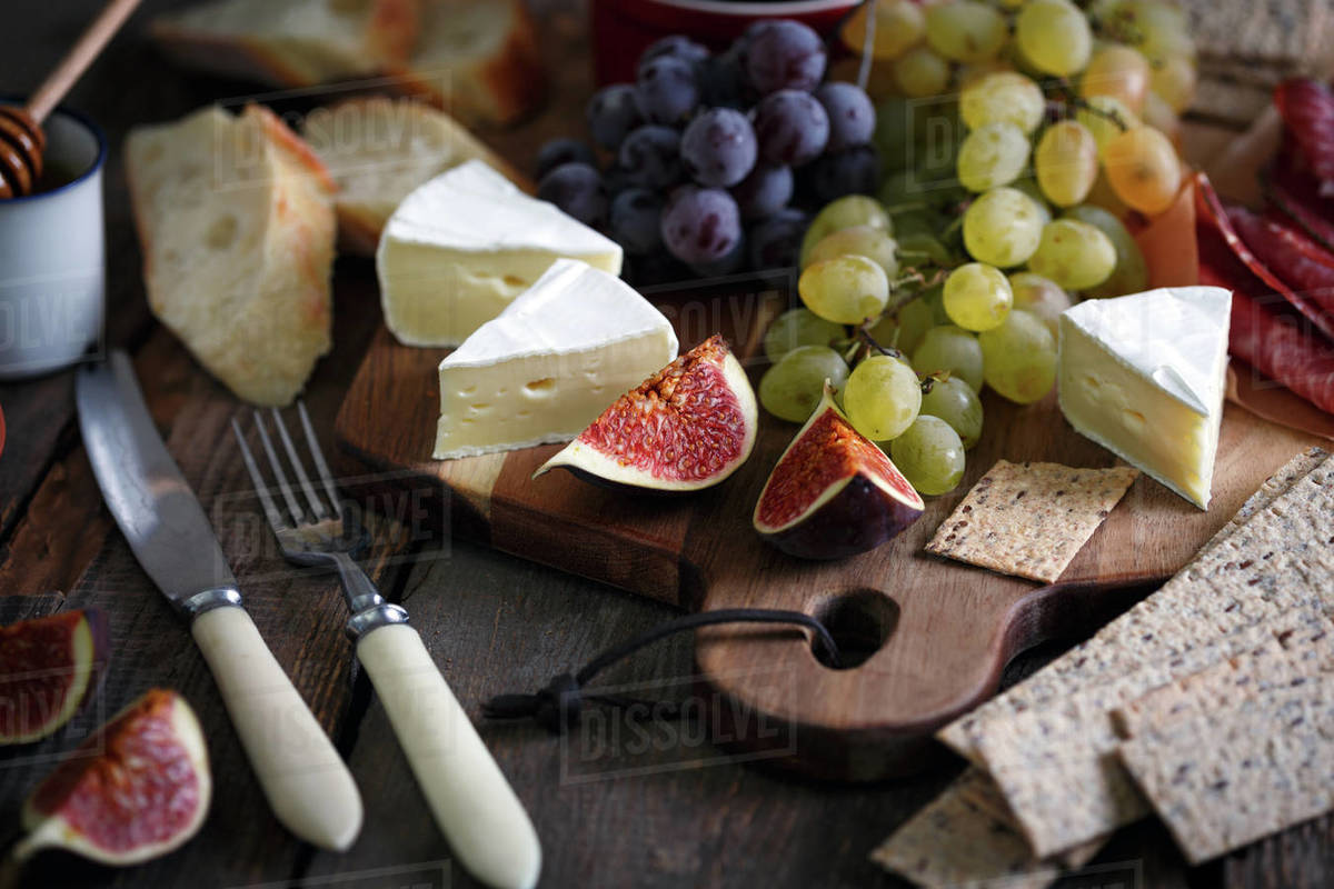 Italian breakfast - grapes, brie cheese, salami, figs and olives ...