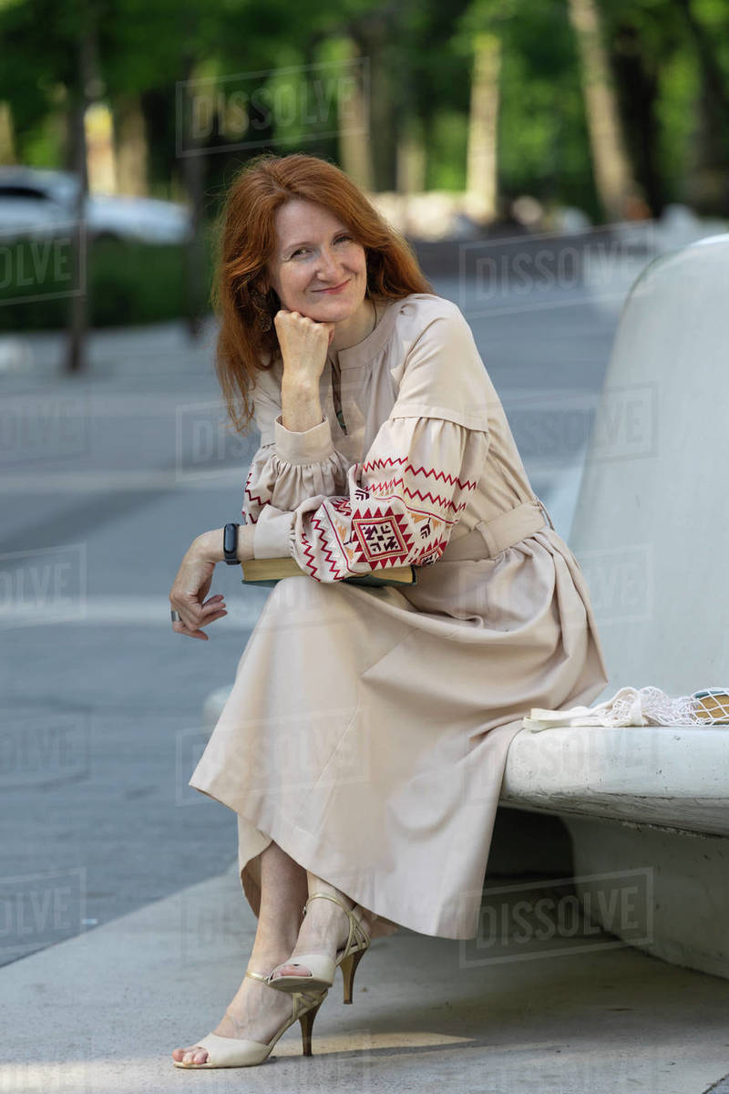 Ukrainian girl in vyshyvanka sitting on a bench with a book - Royalty ...