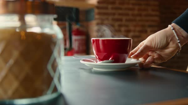 Waiter or customer put cup of hot coffee on table - 4K Royalty-free ...