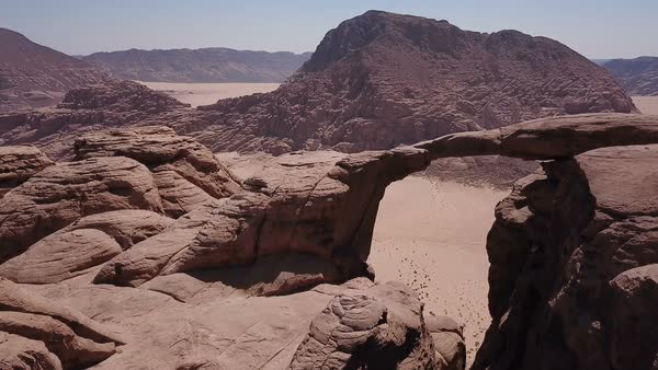 Drone flying over natural arch stone bridge in desert - Stock Video ...