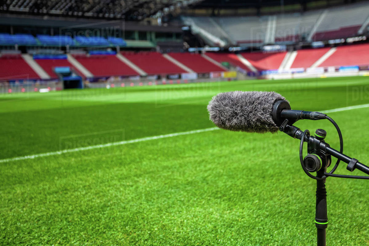 Directional microphone on a football field to record the sound of a ...
