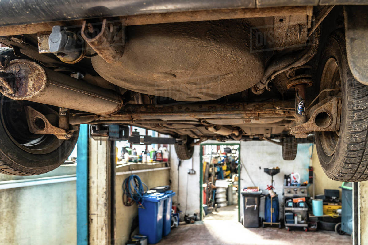car on jack during repair in service. - Stock Photo - Dissolve