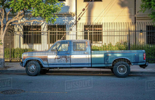 old rusted van on city street - Stock Photo - Dissolve