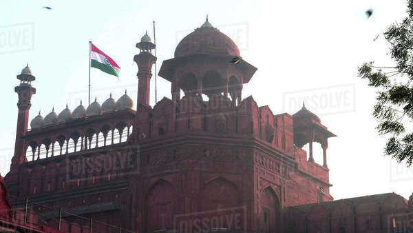 an exterior view of red fort's tower domes and a flag at old delhi ...