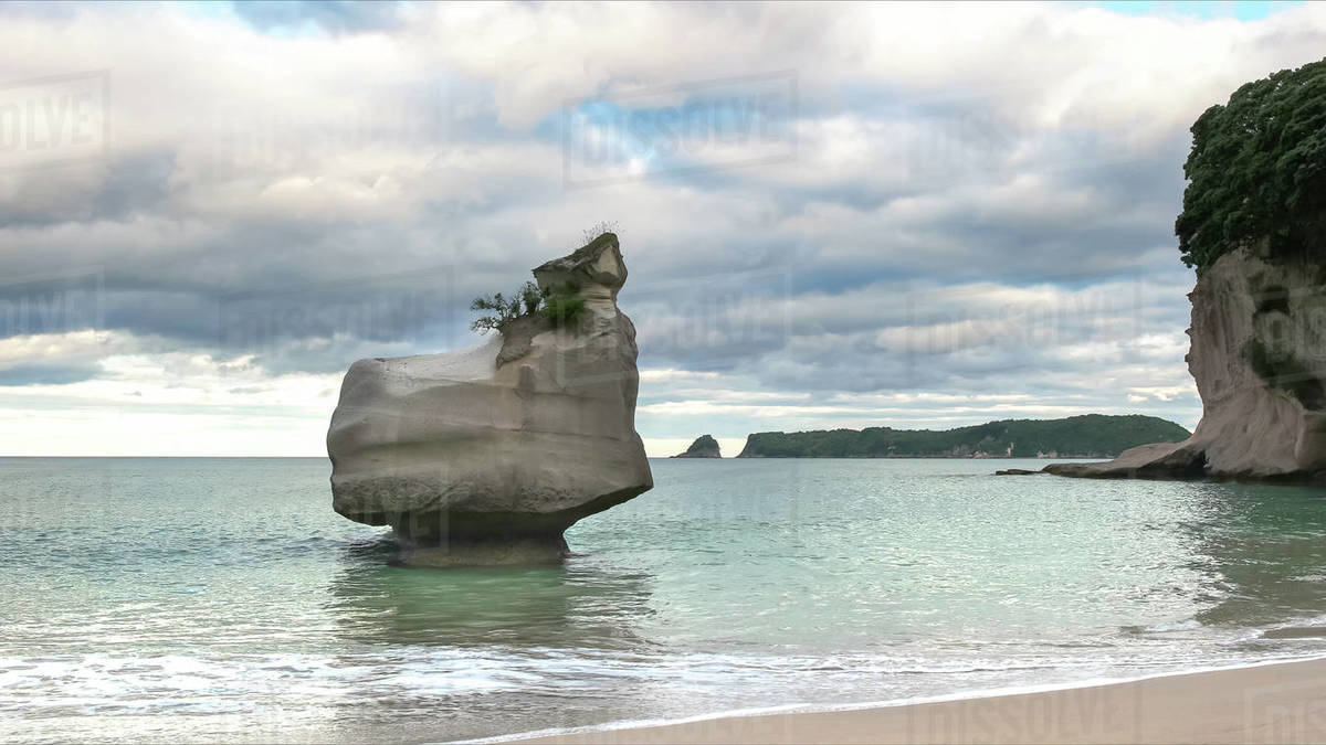 small rock island at cathedral cove on the north island of new zealand ...