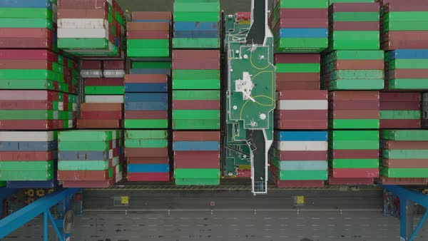 Top down shot of colourful containers loading on big cargo boat ...