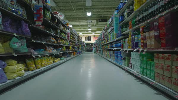 Empty shop after closing. Low flight on aisle between shelves. Interior ...