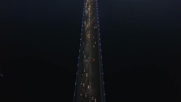 Birds Eye Top Down View of Bridge at Night with Car traffic looking up ...