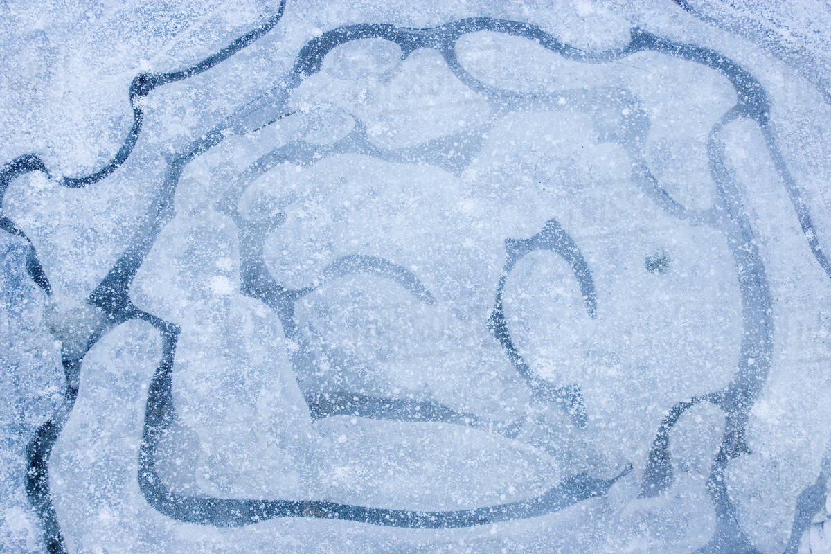 Patterns in a frozen puddle. - Royalty-free Stock Photo | Dissolve