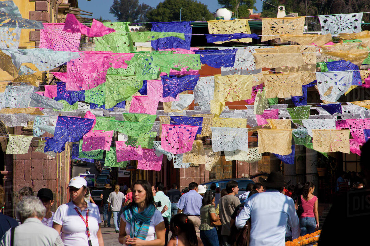 Mexico, San Miguel de Allende. Banners fly over people's heads in the ...