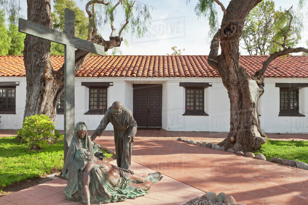 USA, California, San Diego. Religious statues and cross outside ...