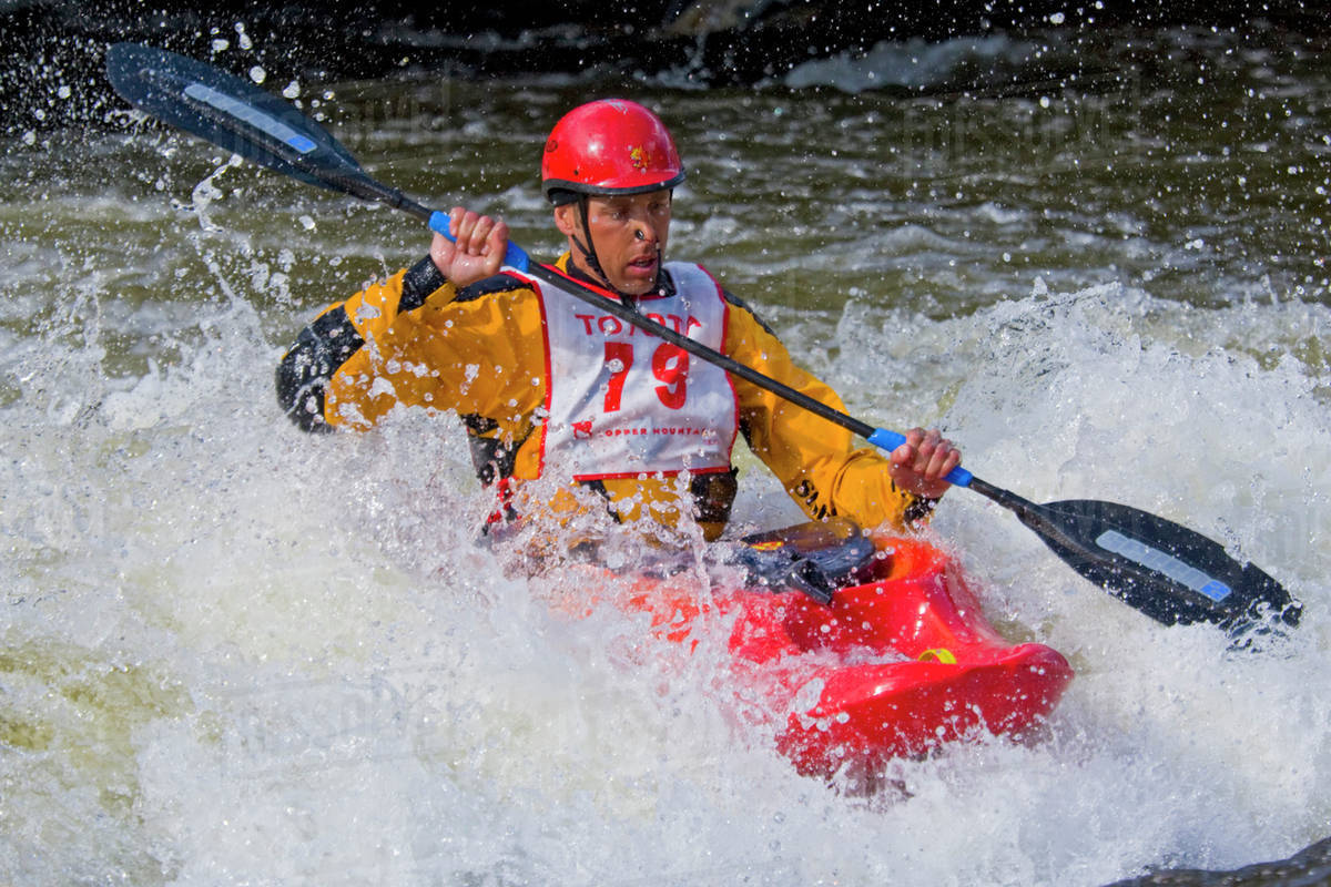 USA, Colorado, Frisco. Male competitor in Kayak Rodeo on Ten-Mile Creek ...