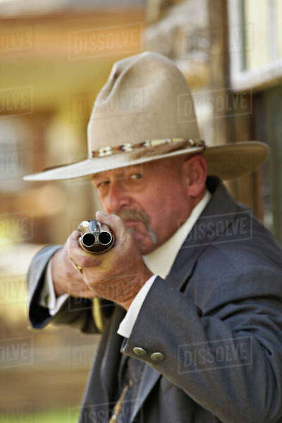 Sheriff aiming double barreled shotgun, Virginia City, Montana ...