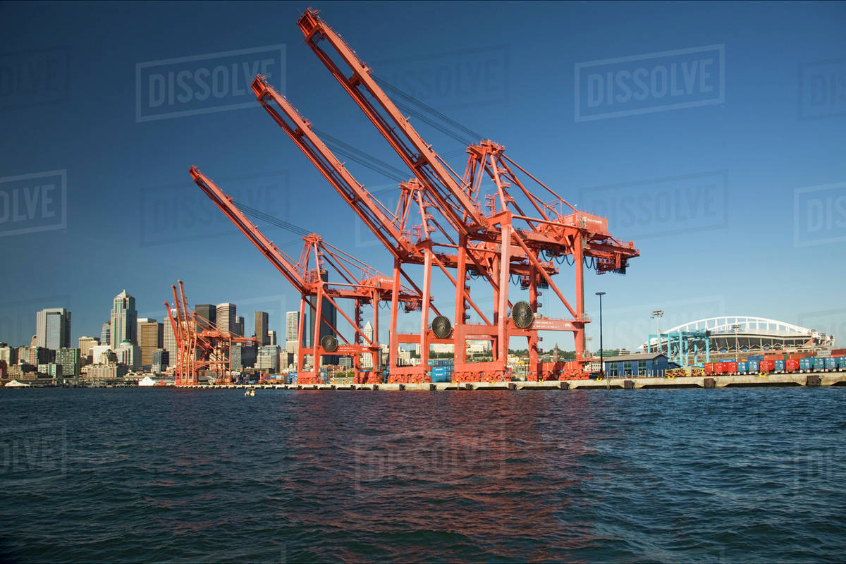 WA, Seattle, Seattle skyline with shipping cranes from Elliott Bay ...
