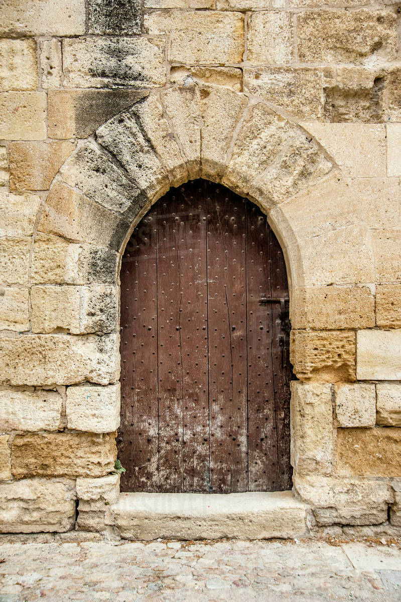 French medieval arched door in stone wall - Royalty-free Stock Photo ...