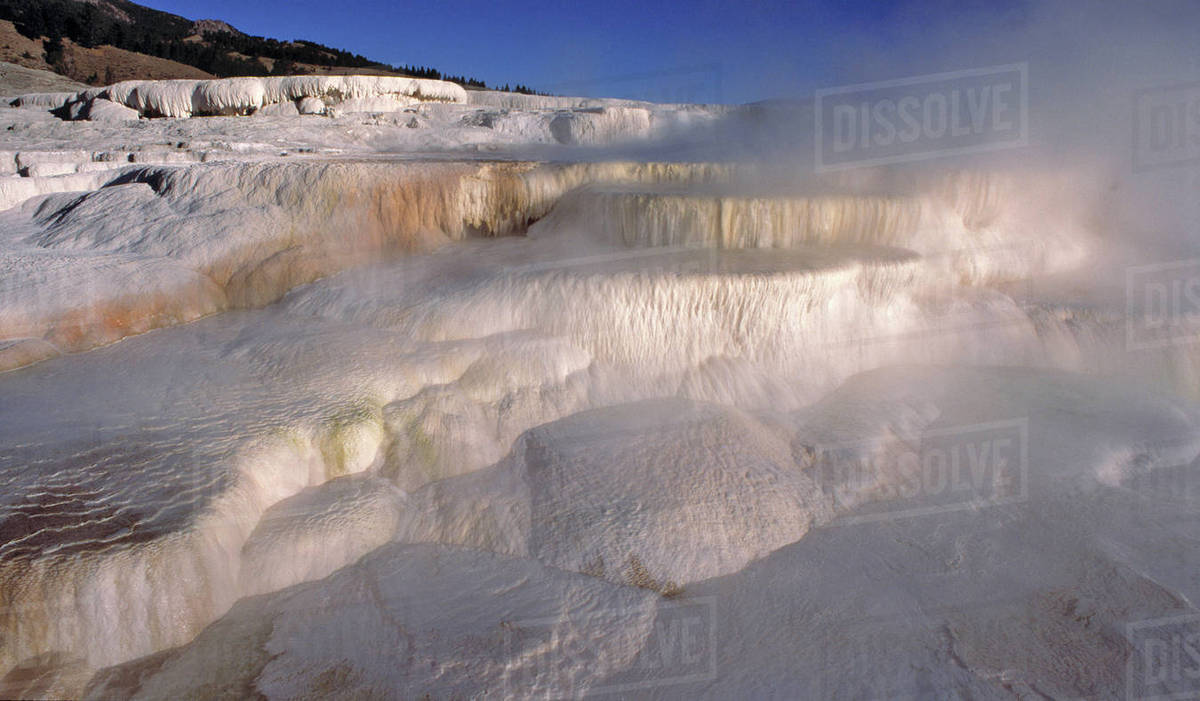 USA, Wyoming, Yellowstone National Park. Mist from Mammoth Hot Springs ...